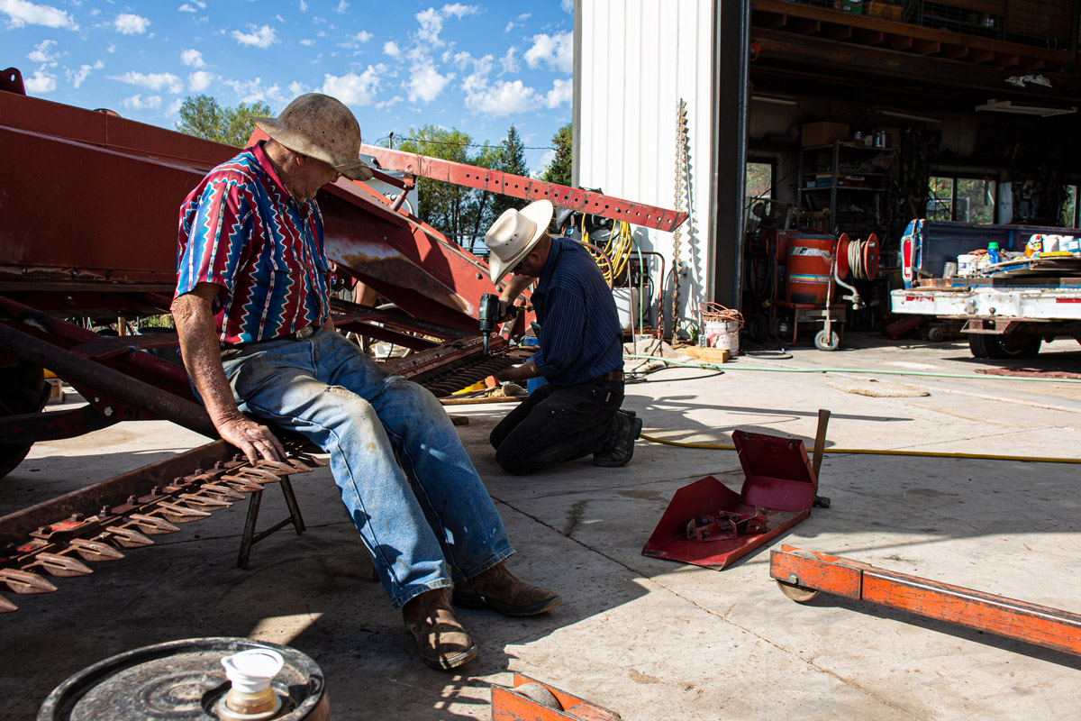 Ron Bartee and his son Dale Bartee work on modifying a grain combine ...